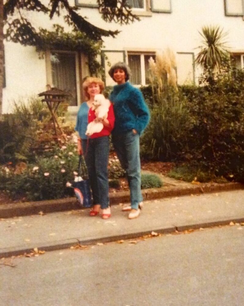 A Photograph of Marlow Monique Dickson Standing on the Sidewalk with a ...